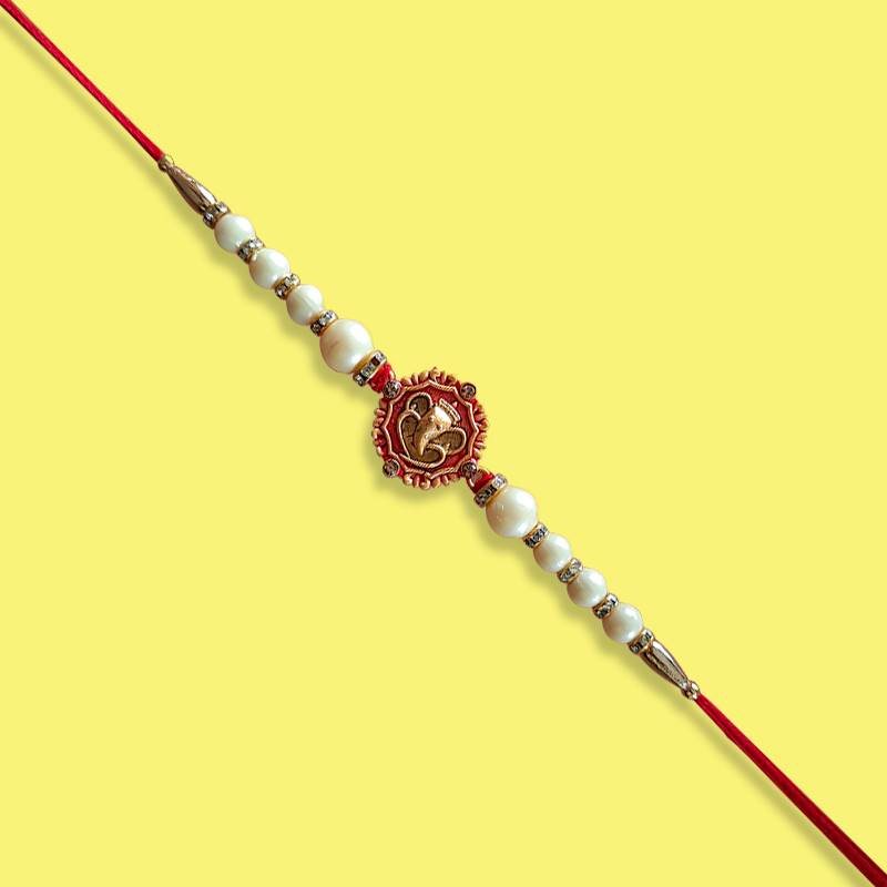 Auspicious Ganesh Rakhi with White Pearls - Send Gifts and Money to ...